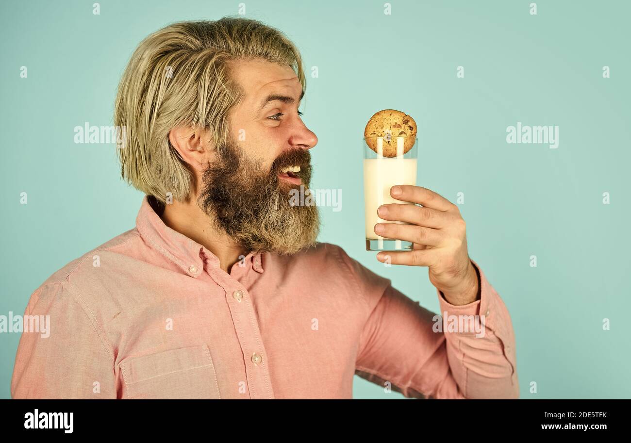 happy farmer eat dessert. bearded man drink useful milk with pastry ...