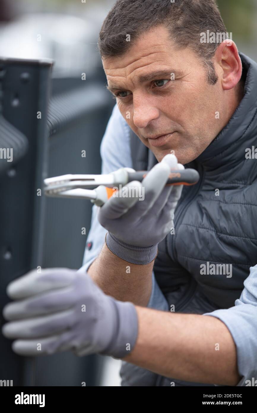 man with gloves using pliers Stock Photo - Alamy