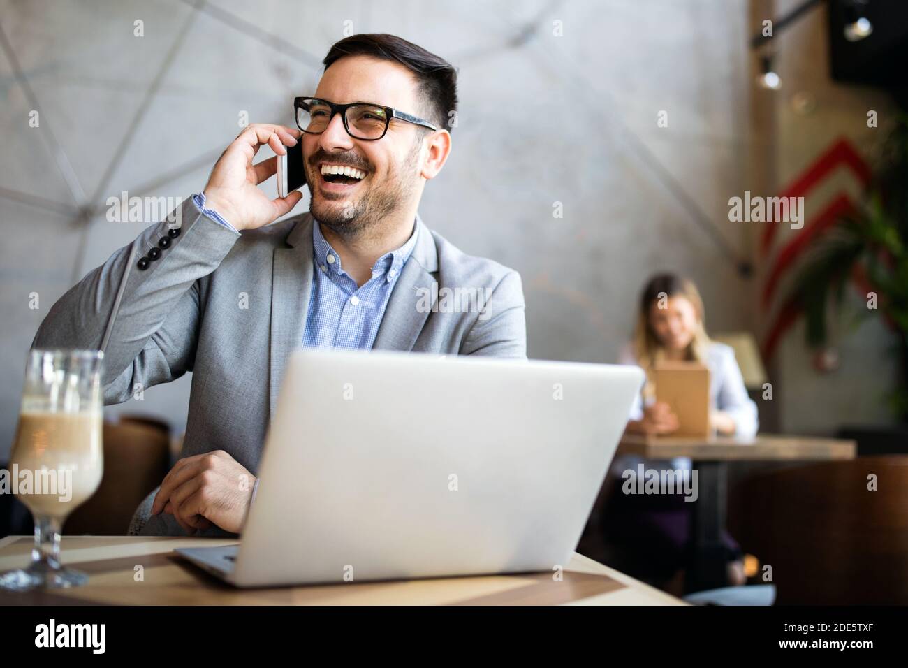 Handsome business man receiving a happy message on his cell phone Stock ...
