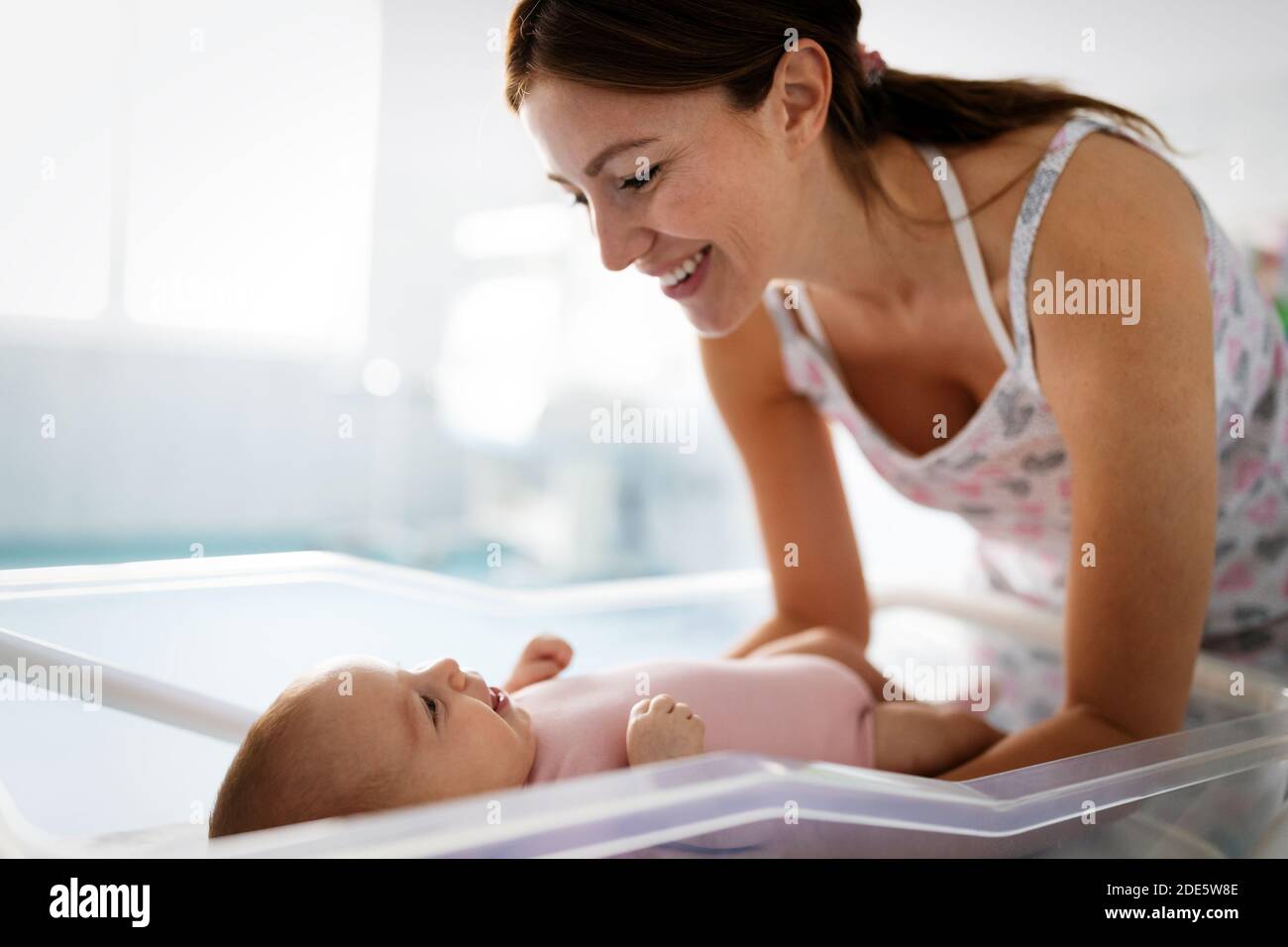 Beautiful mother and her newborn baby together. Love, happiness, family ...