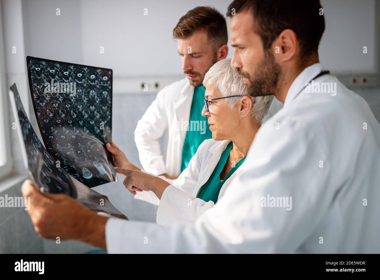 Doctors examining an x-ray report in hospital to make diagnosis Stock ...