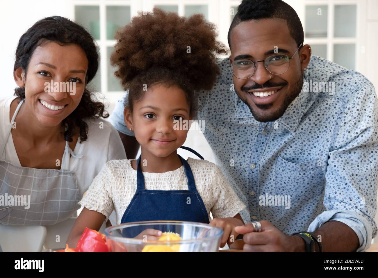 Portrait of happy black family of three at modern kitchen Stock Photo ...