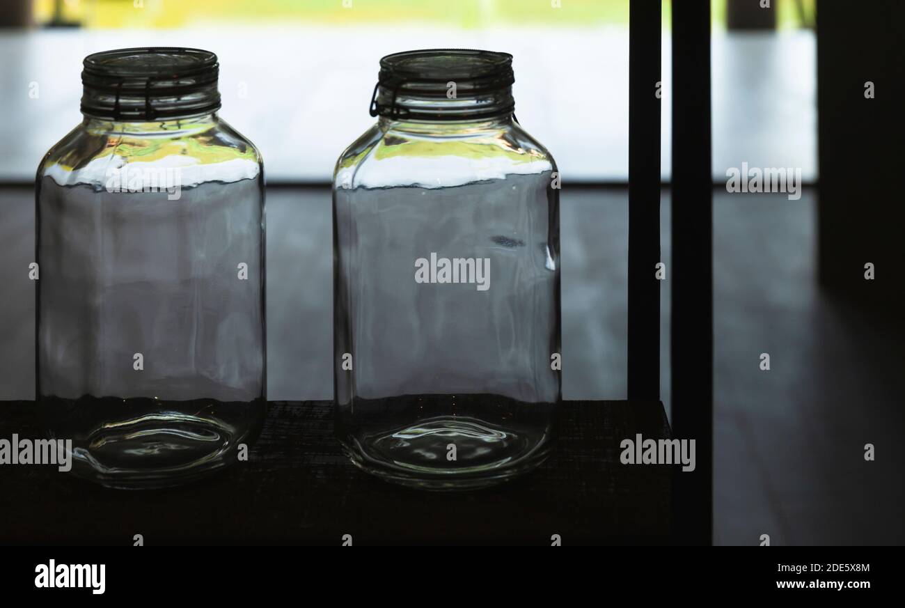 Two empty glass jars are on a shelf Stock Photo - Alamy