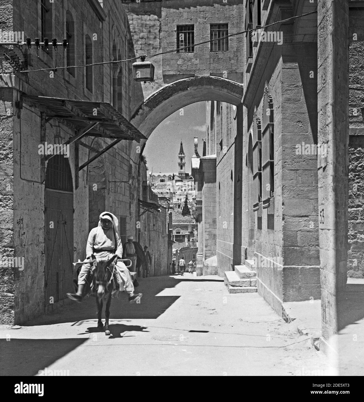 Original Caption: Ecce Homo arch man on donkey - Location: Jerusalem ca ...