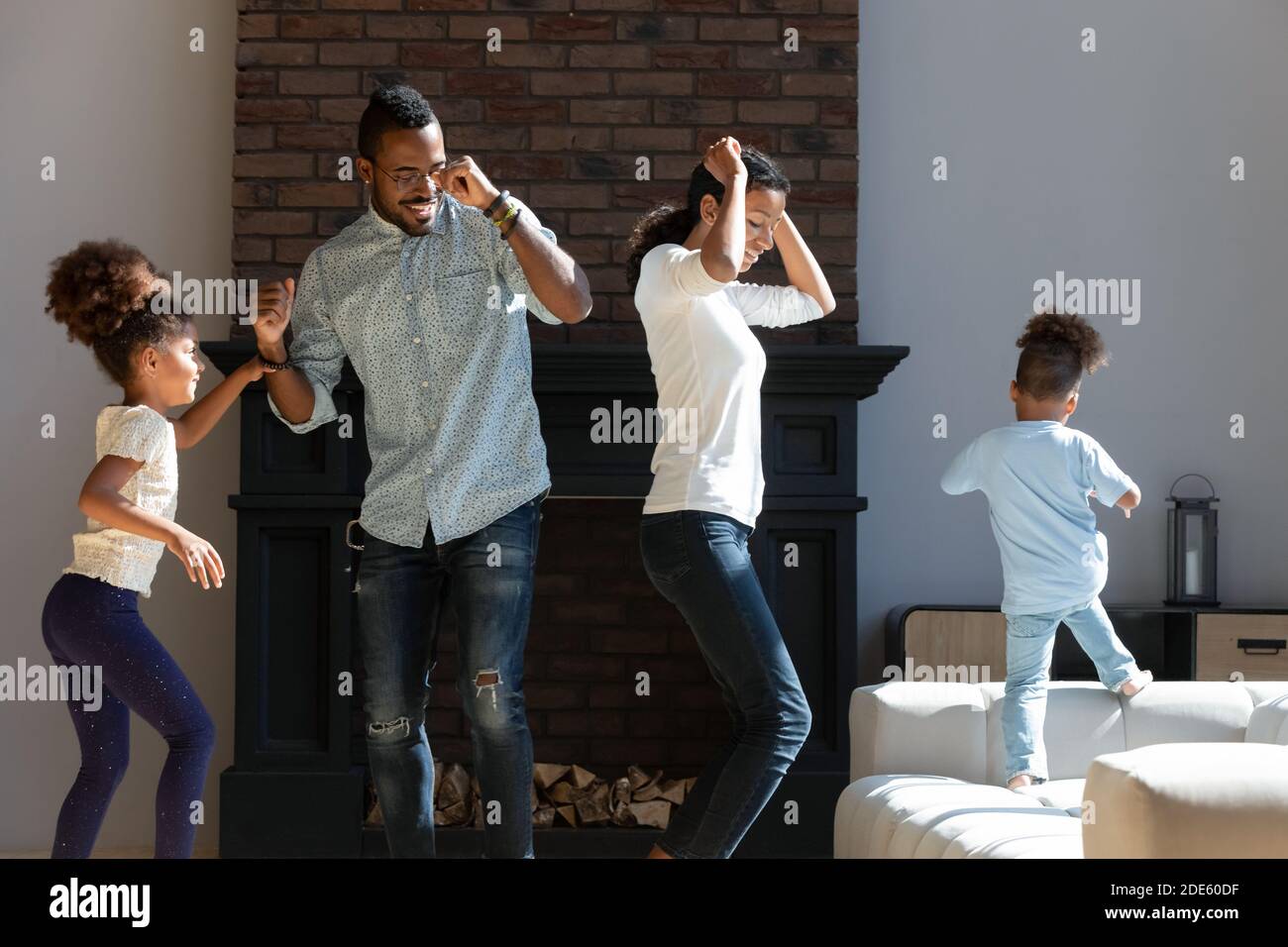 Happy african american spouses and two kids dancing at home Stock Photo ...