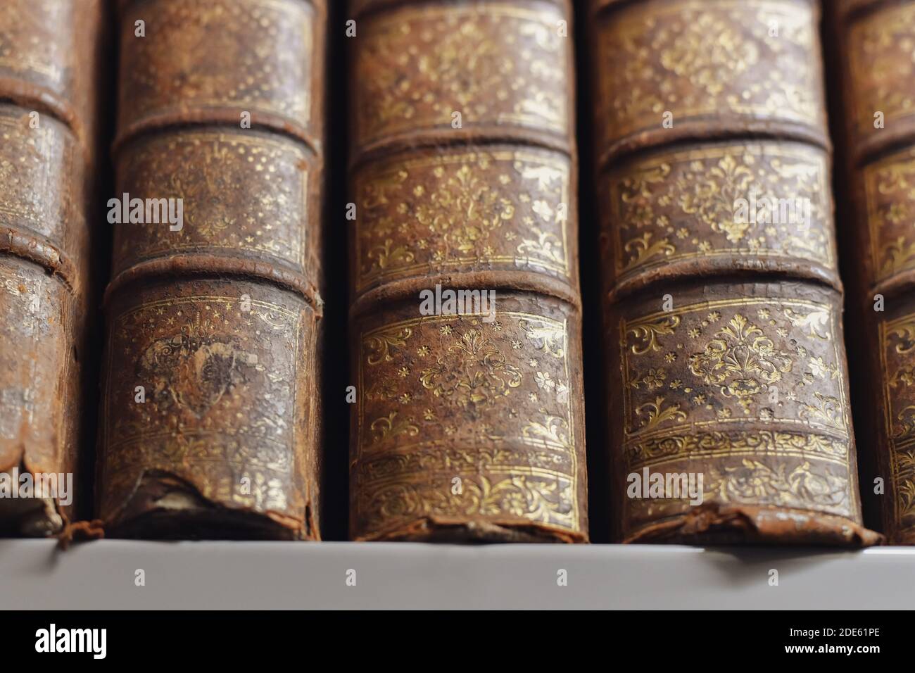 Antique gold-plated books on shelves in a library Stock Photo - Alamy