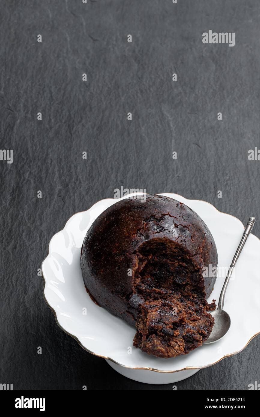 Traditional festive christmas pudding on black stone background Stock ...