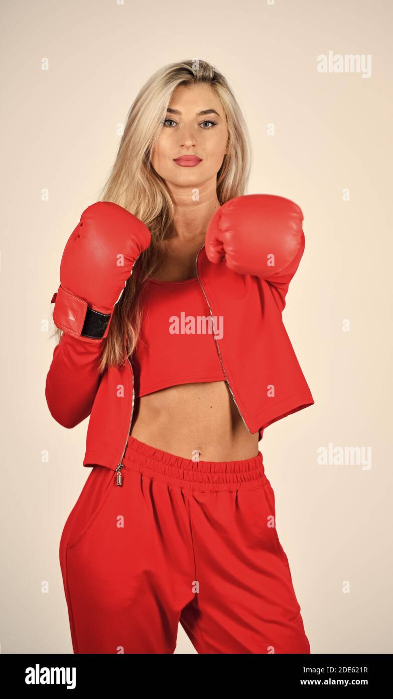 Sport and sportswear fashion. girl in boxing gloves punching. training ...