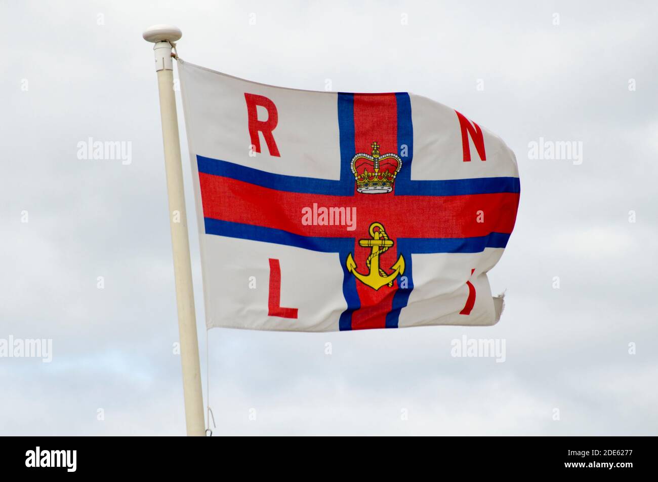 RNLI Flag Flutters In The Wind From A Mast In Brixham Harbour Devon ...