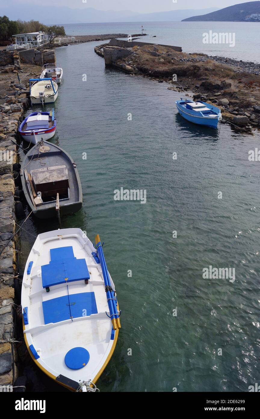 Line of boats docked in the water channel leading to the lagoon of ...