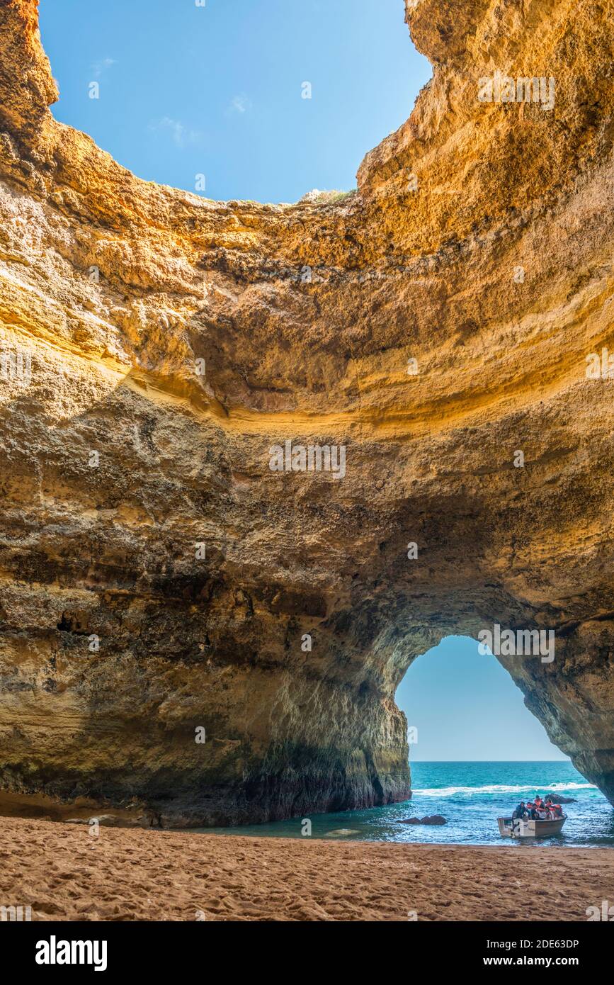 Benagil sea cave, from inside, with visitors and boat, Algarve ...