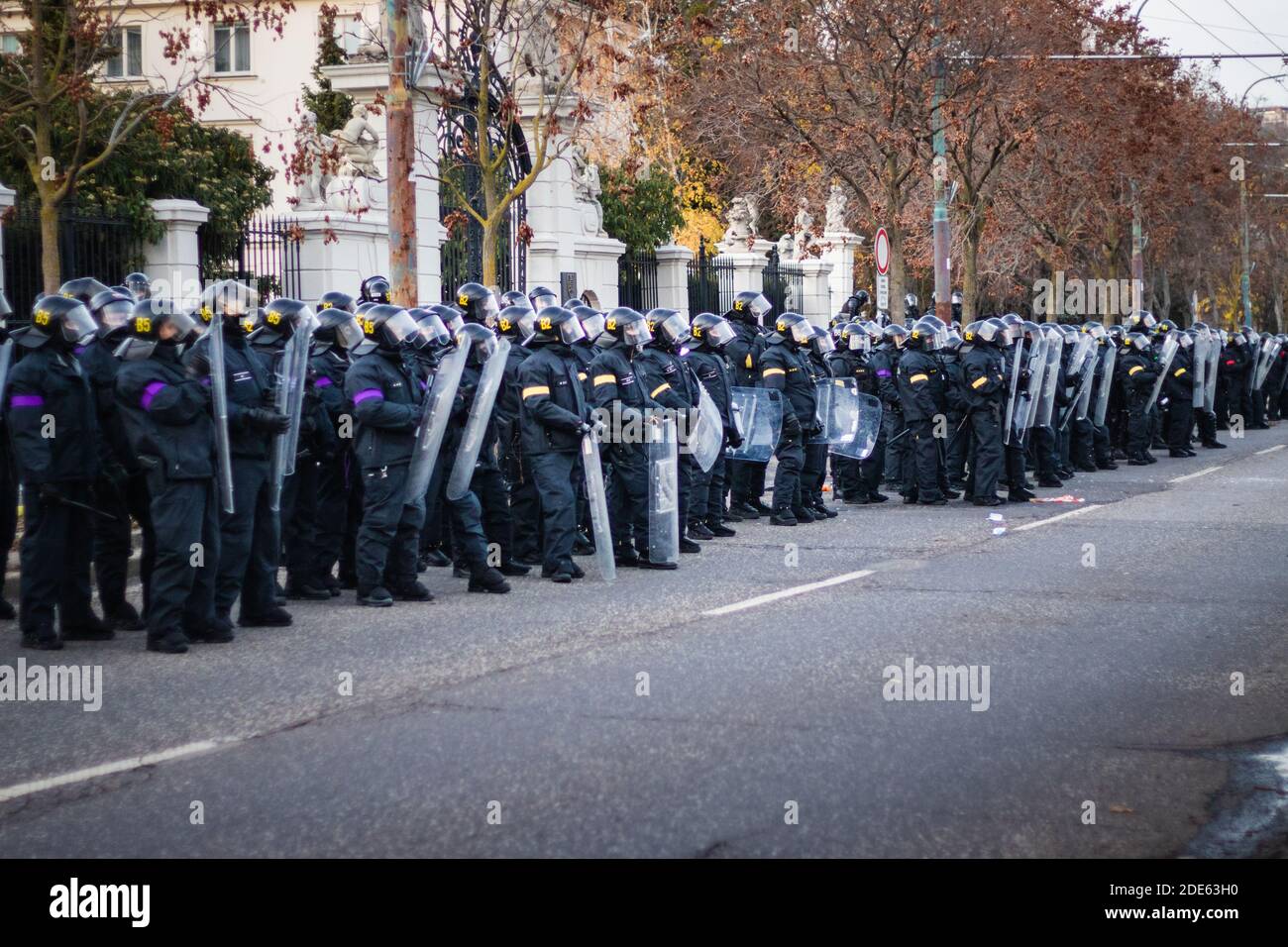 Huge crowd line of armed police officers with shields guarding building ...