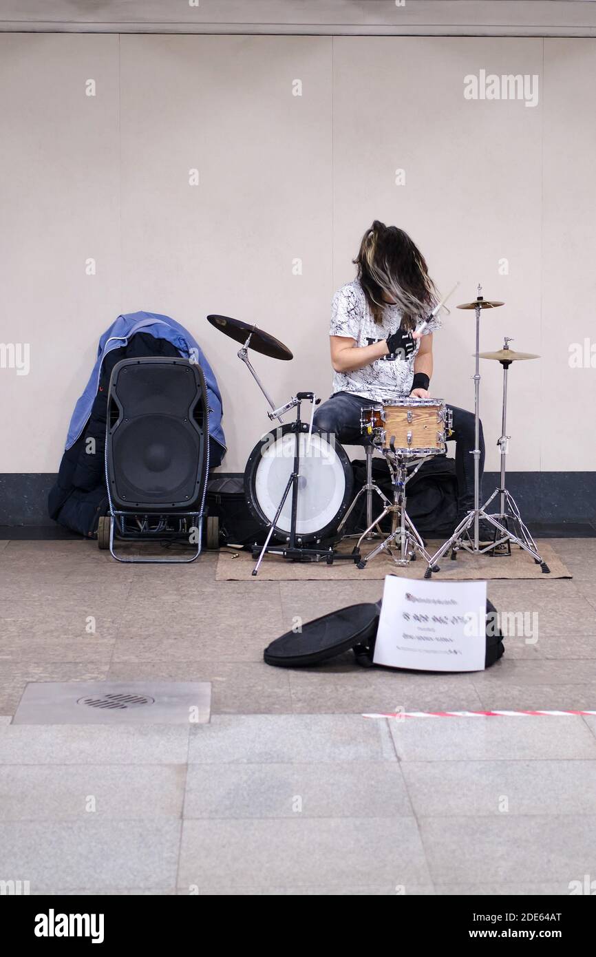 Street musician drummer playing musical instrument at subway station ...