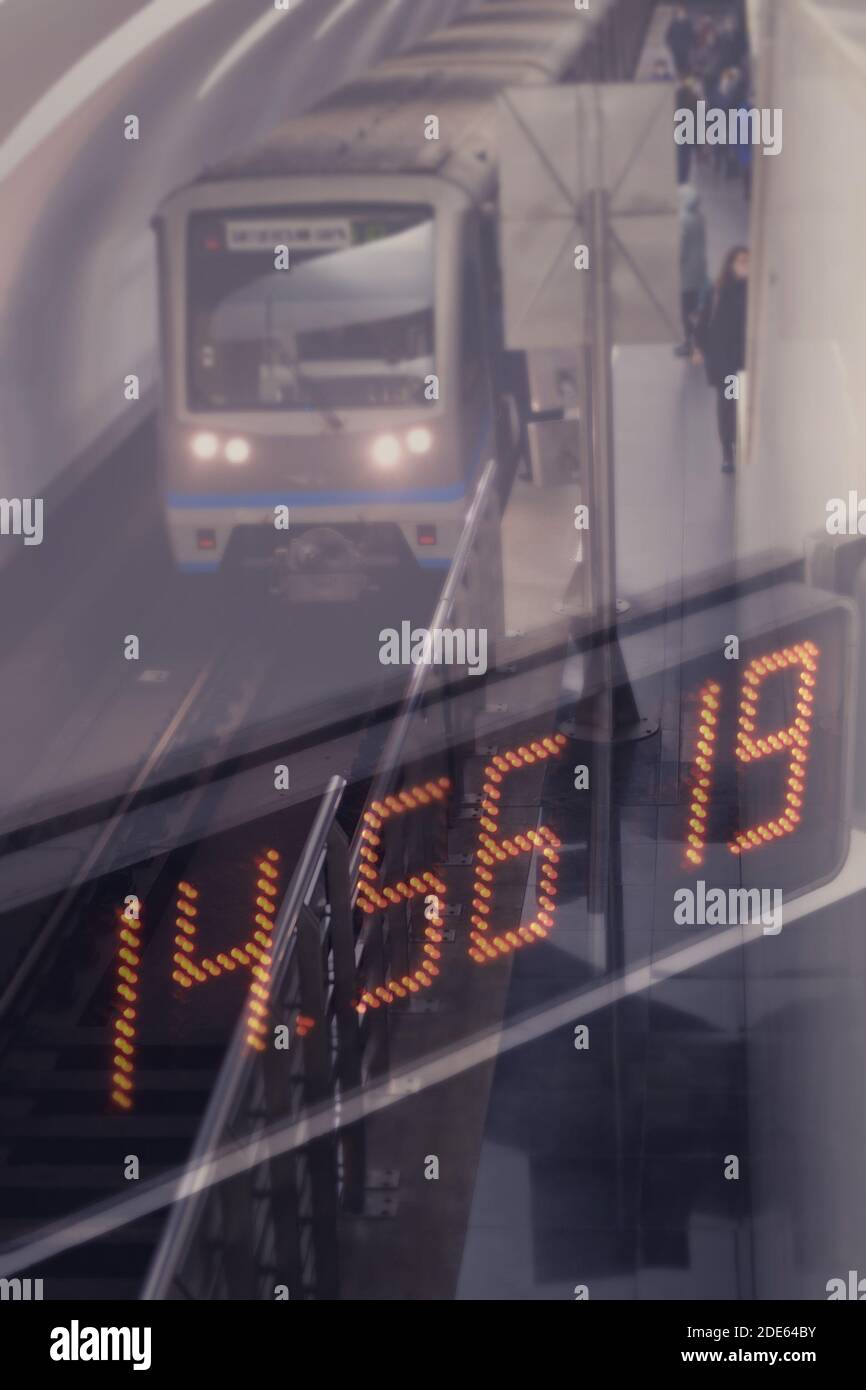 The departing metro train and the time and time of the schedule on the ...