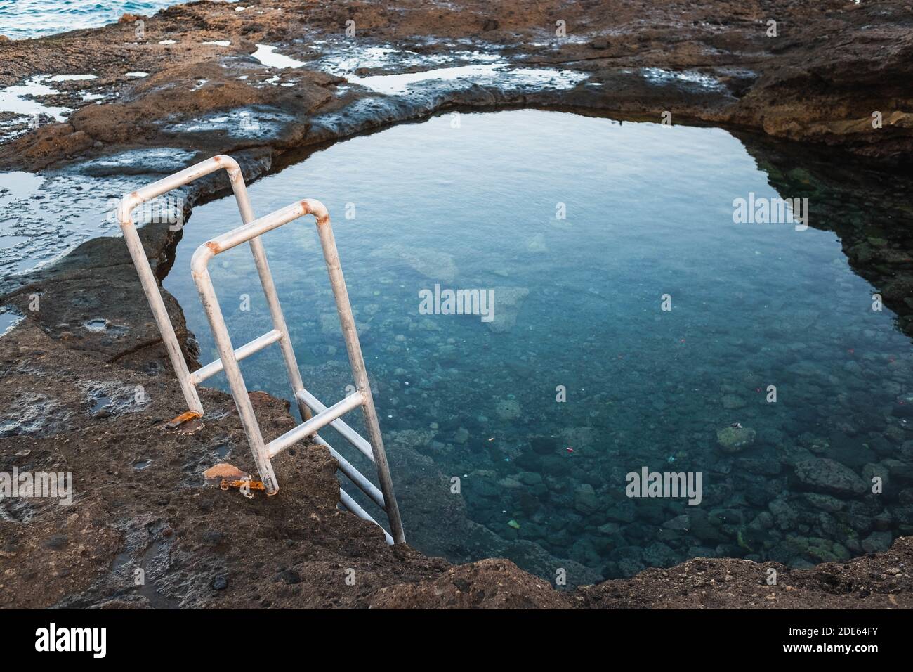 A landscape of ladder going down a lagoon Stock Photo - Alamy