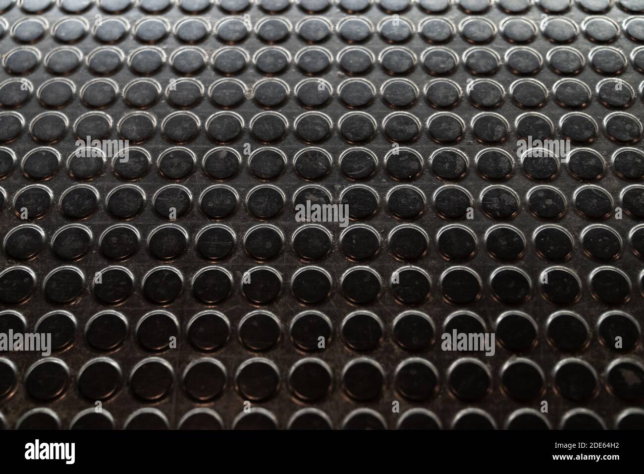Black rubber floor with dots, non-slip matting in industrial setting ...
