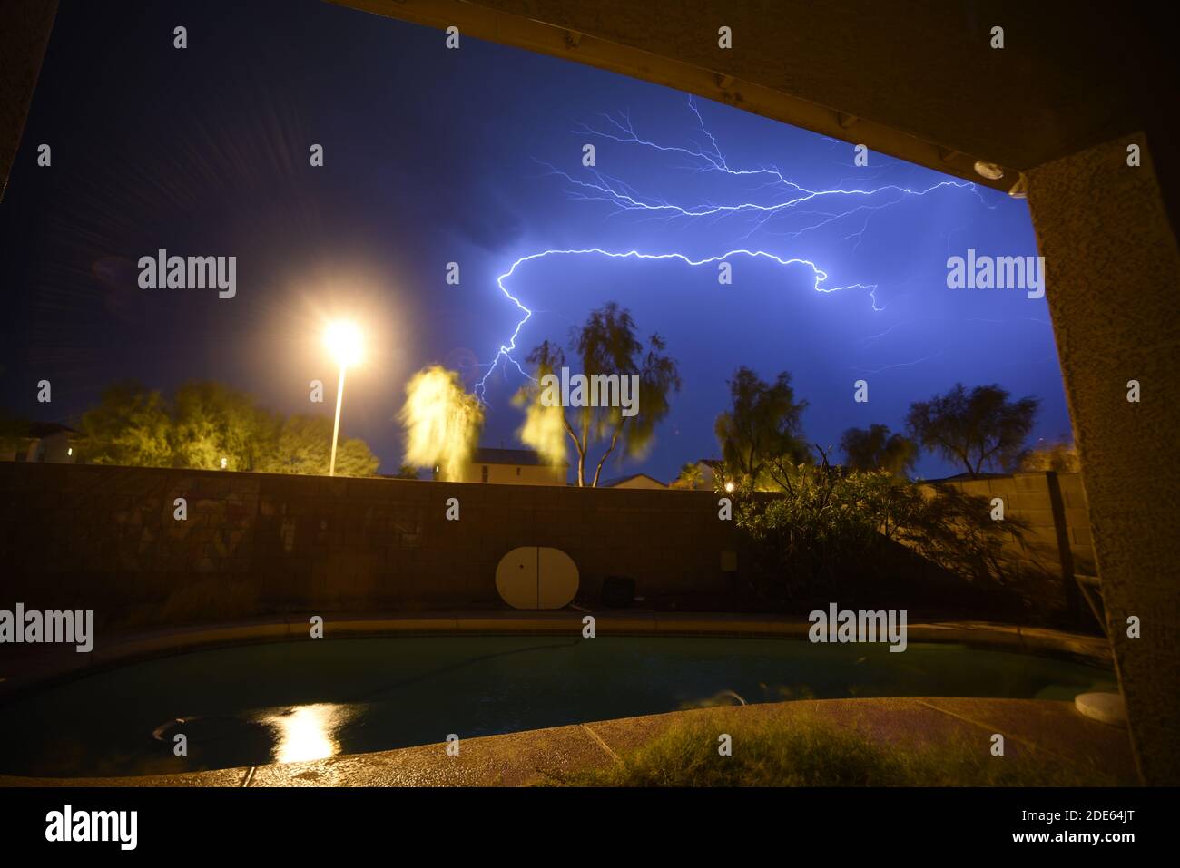 Amazing Thunders storm over a pool in the backyard of a house Stock ...