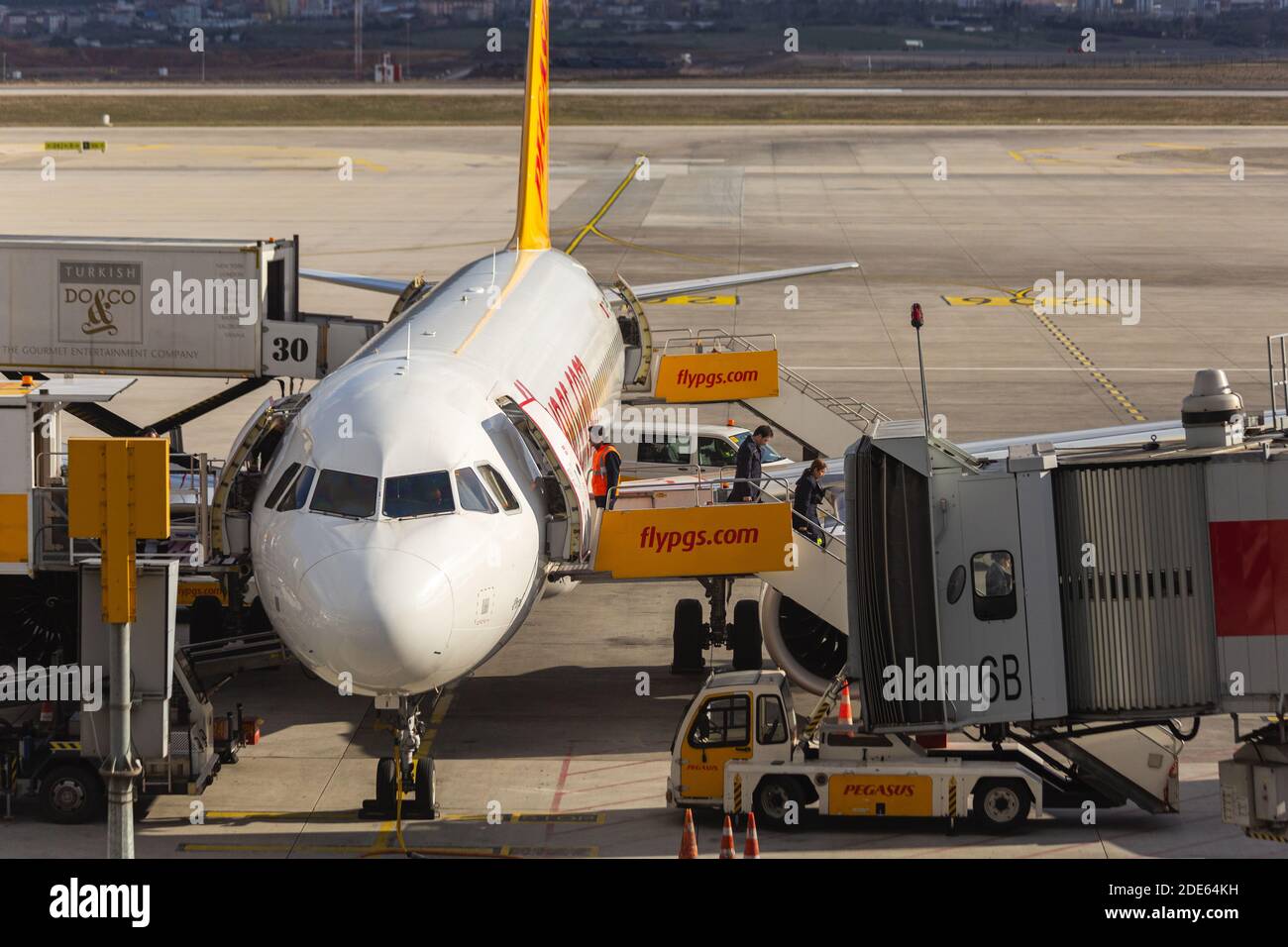 Airbus A320 type airliner parked in service area with ambulift ...
