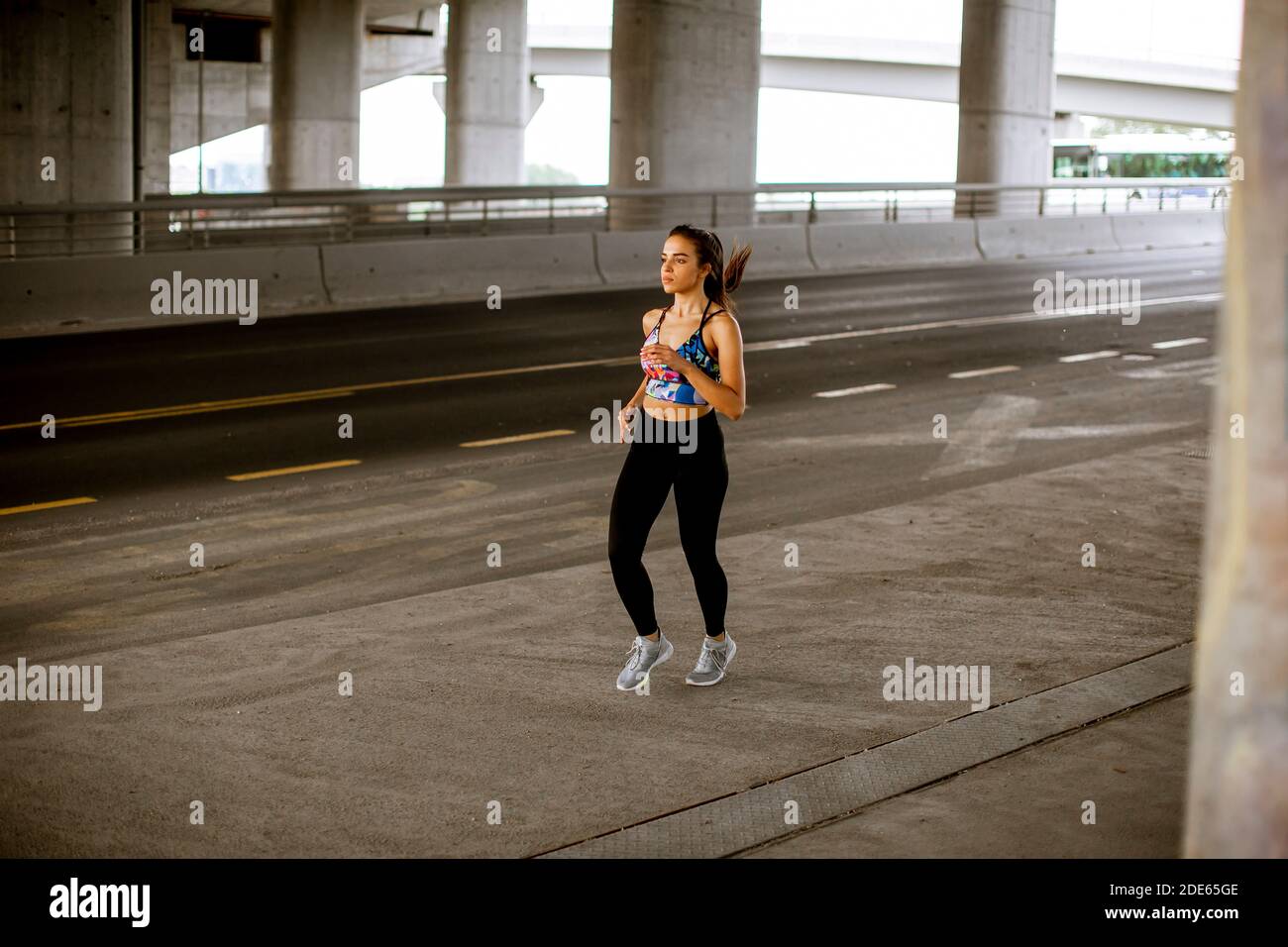 Pretty young woman running in the urban environment Stock Photo - Alamy