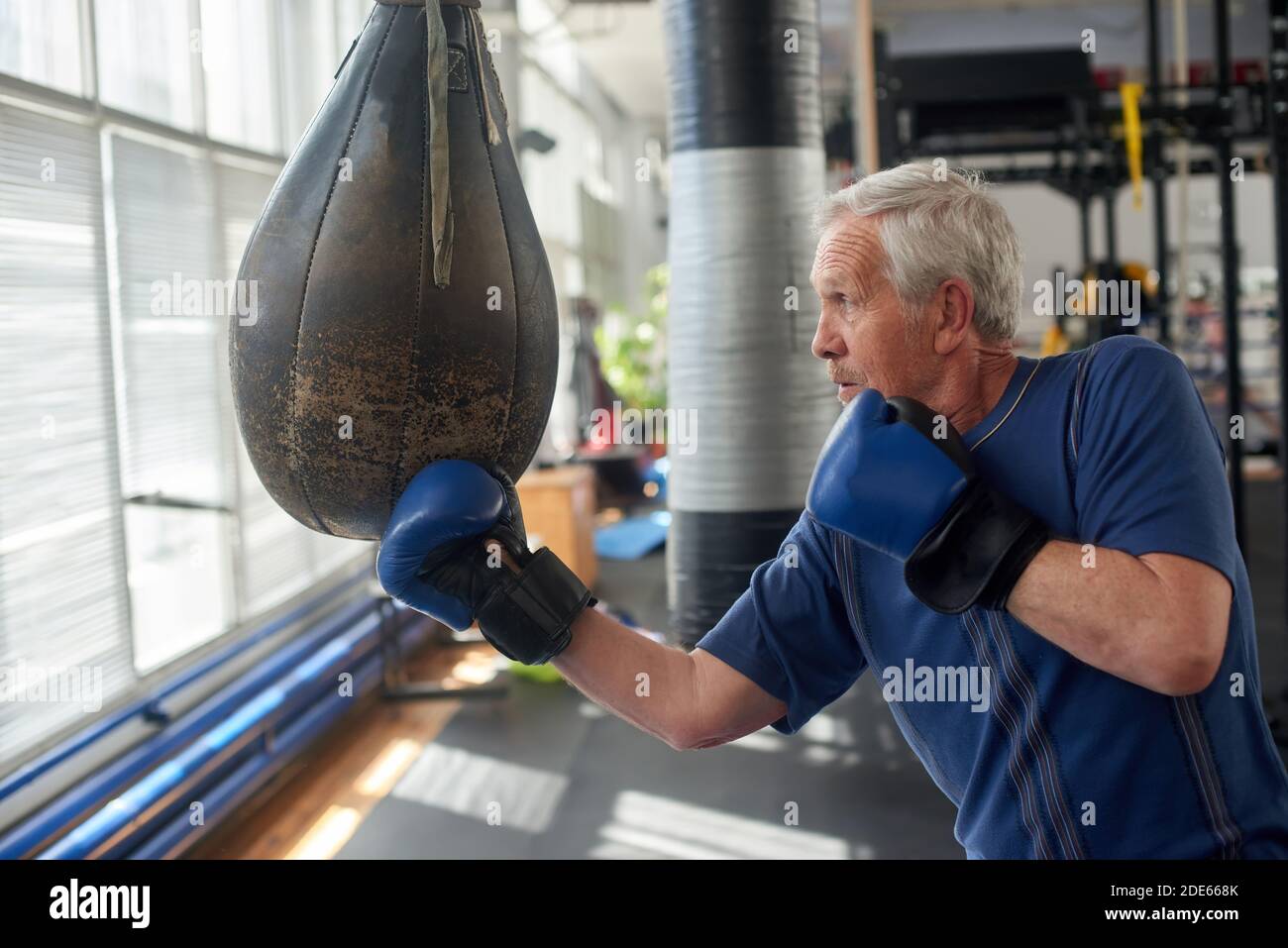 Man punching punch bag hi-res stock photography and images - Alamy
