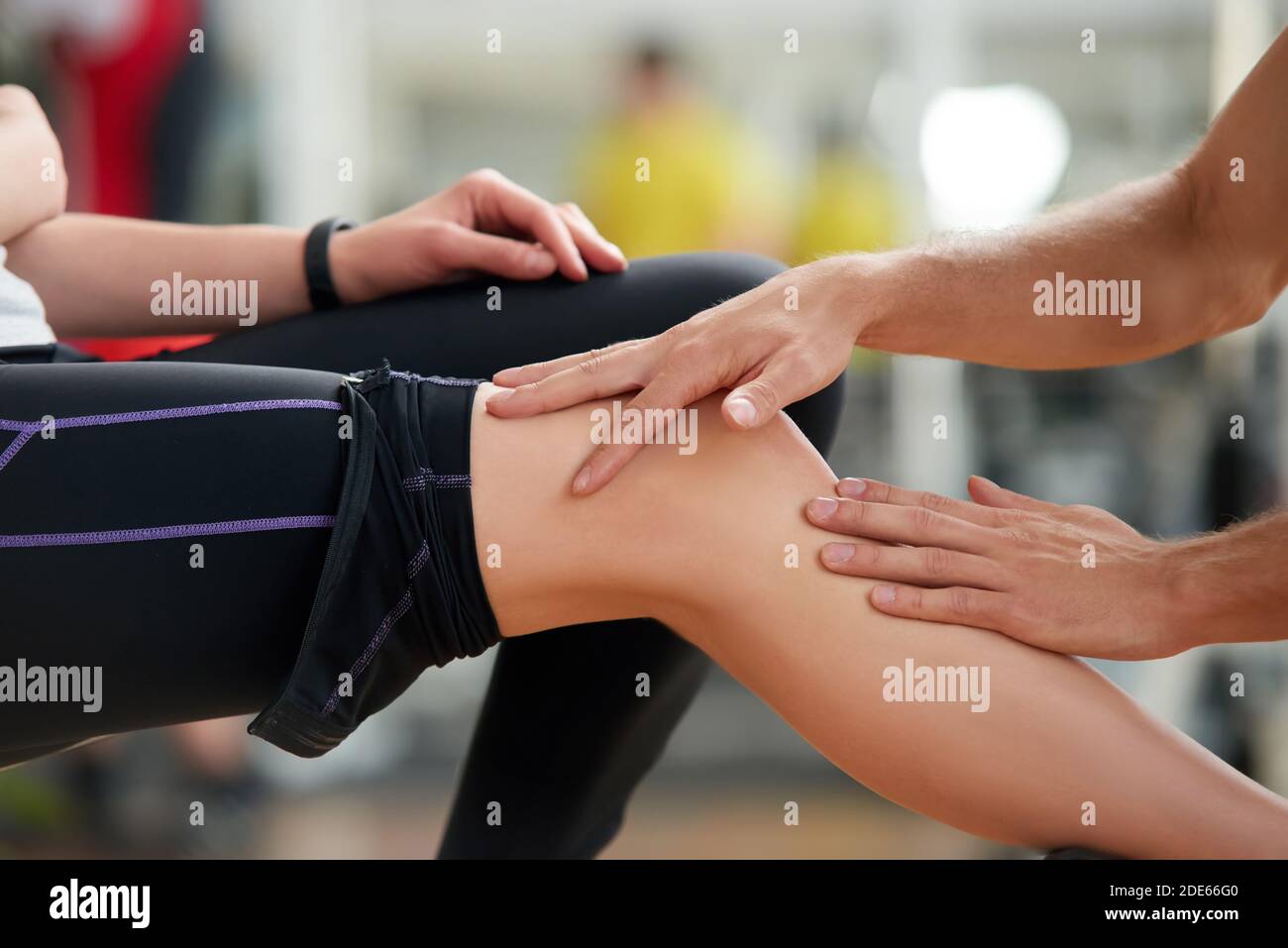 Young woman suffering from leg pain after workout Stock Photo - Alamy