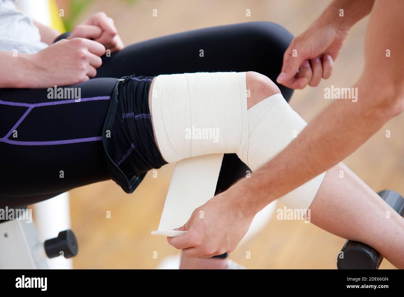 Applying a compression wrap for a sprained muscle Stock Photo - Alamy