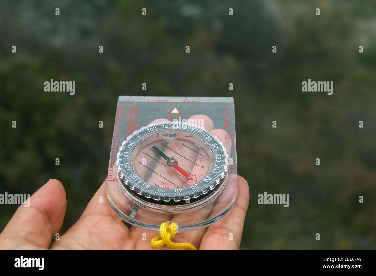 Hand holding liquid filled protractor Stock Photo - Alamy