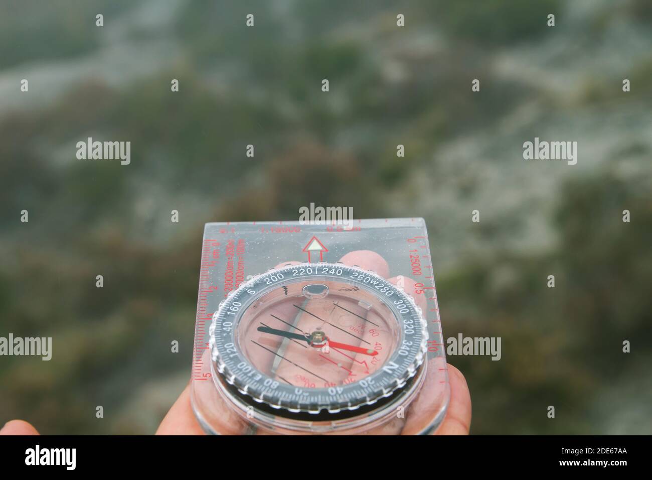 Hand holding liquid filled protractor Stock Photo - Alamy
