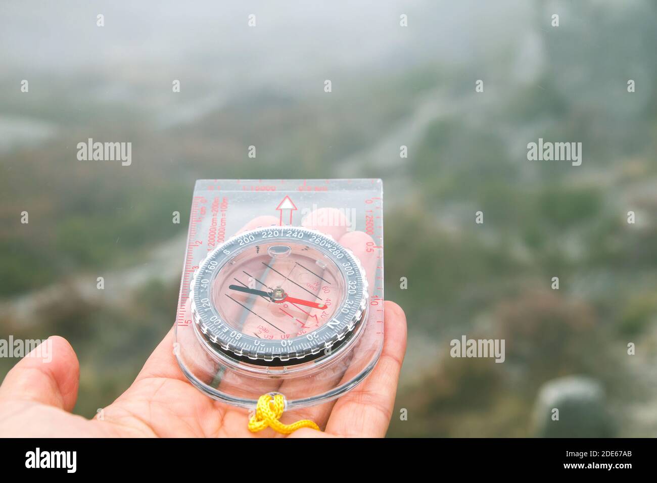 Hand holding liquid filled protractor Stock Photo - Alamy