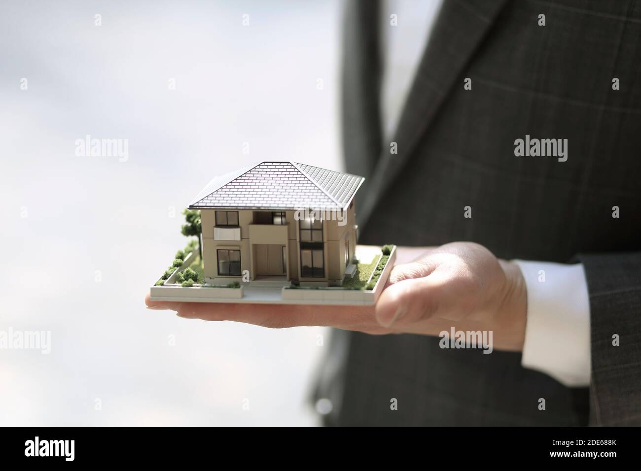Businessman holding model house. Architecture, building, construction ...