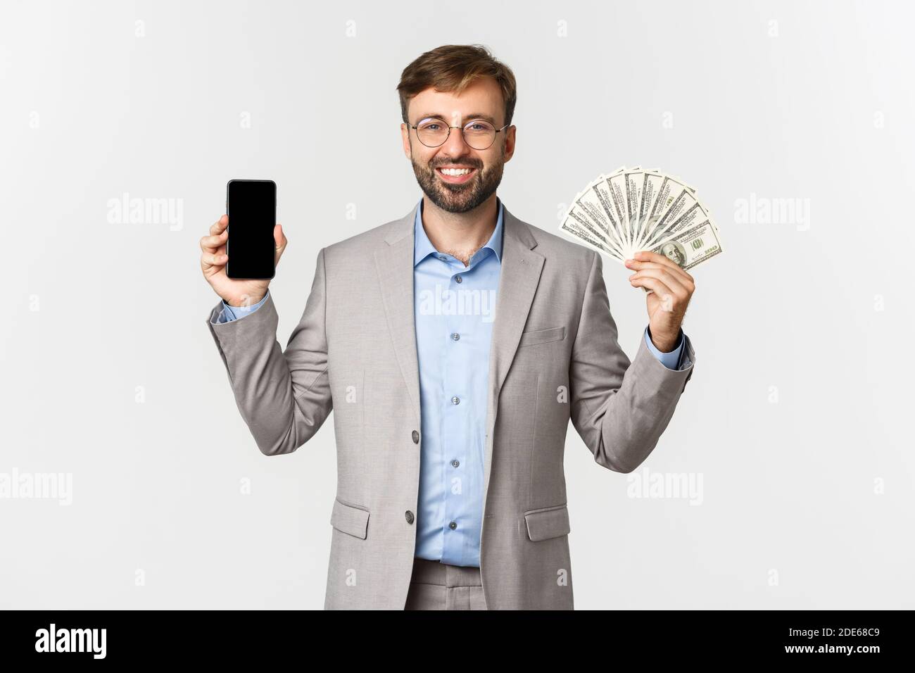 Successful businessman in glasses and grey suit, showing smartphone ...
