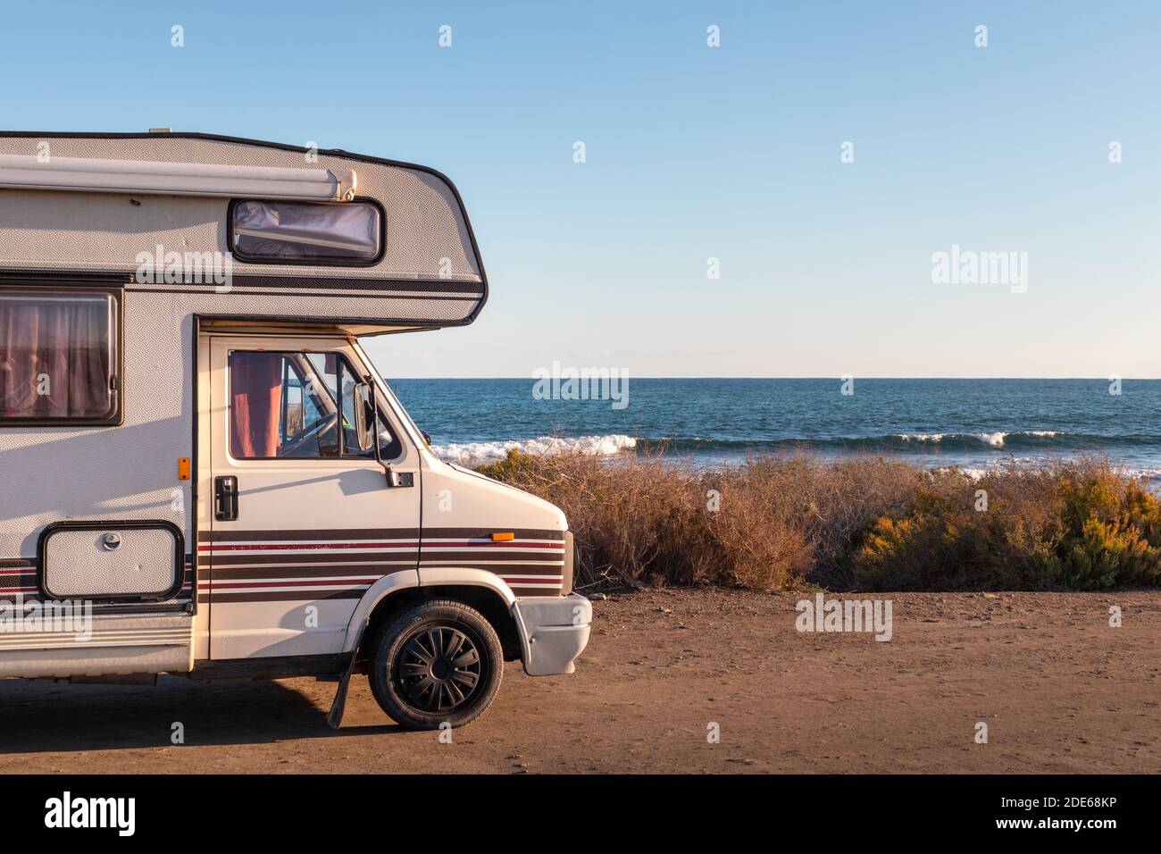 Spain; Nov 2020: Vintage caravan parked in front of the ocean, holidays ...