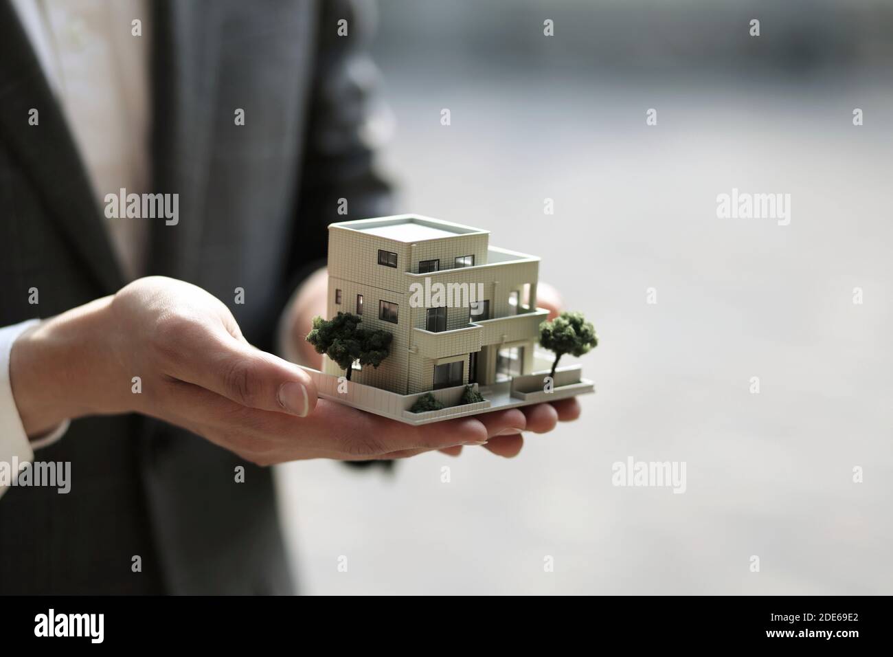 Close up of businessman holding model house. Architecture, building ...