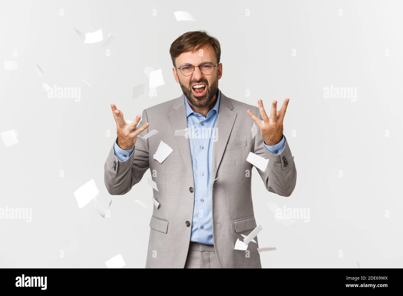 Angry businessman tearing documents and looking frustrated, tossing ...