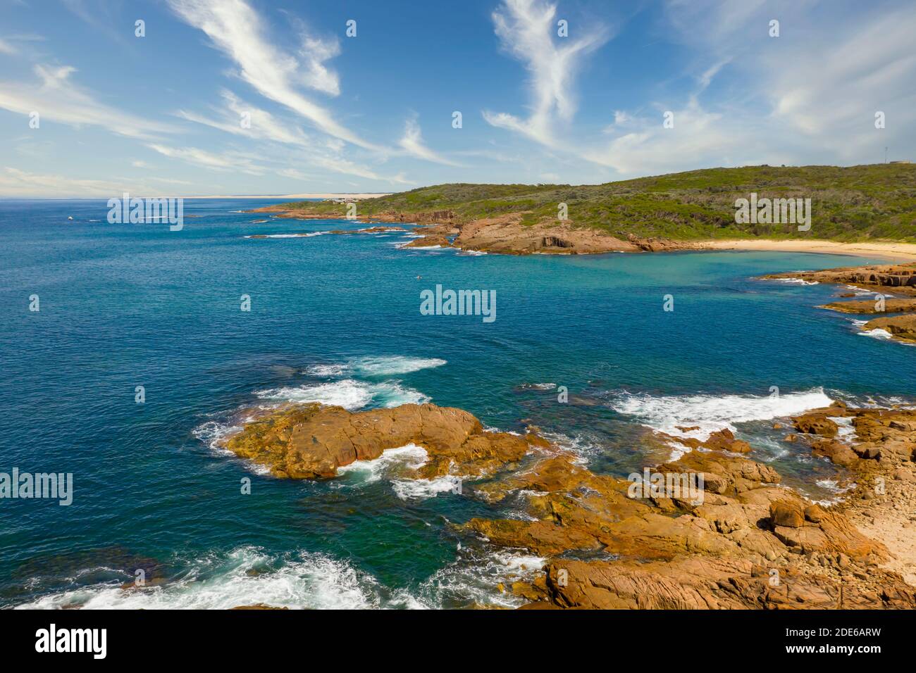 Aerial view of the brown Rocks and blue water of the Tasman Sea at ...