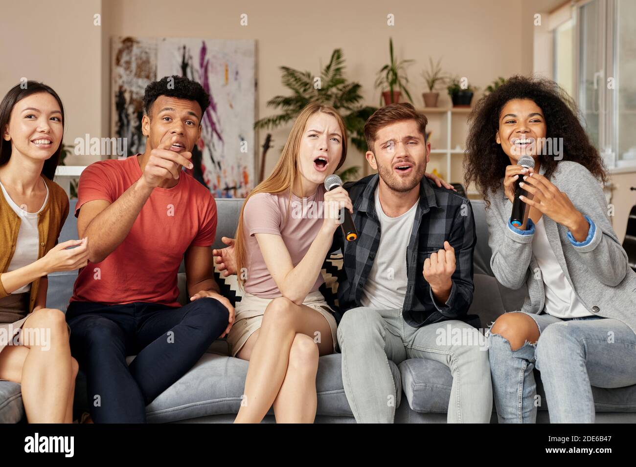 Add music to your party. Group of excited young multicultural friends ...