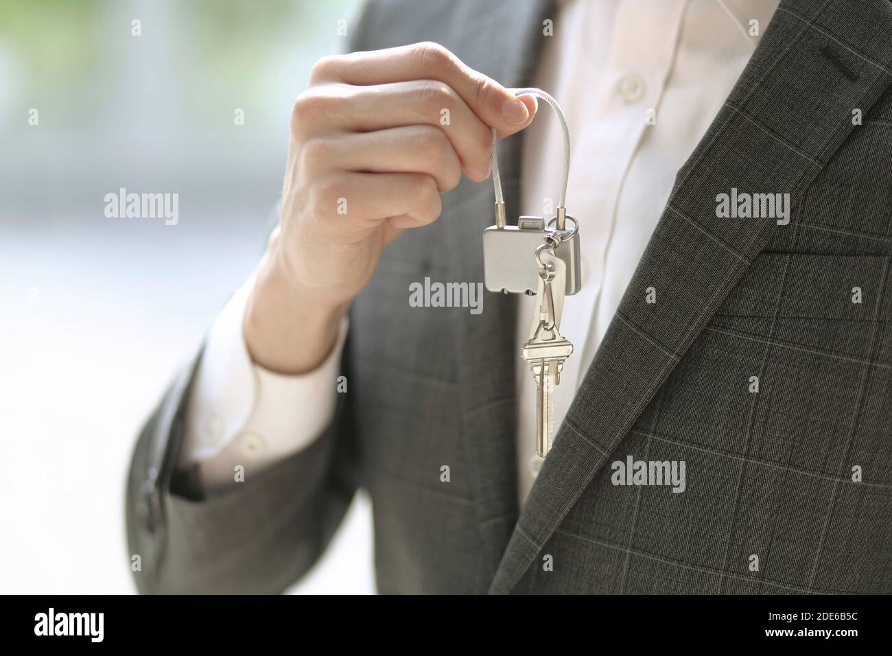 Businessman holding lock and key Stock Photo - Alamy