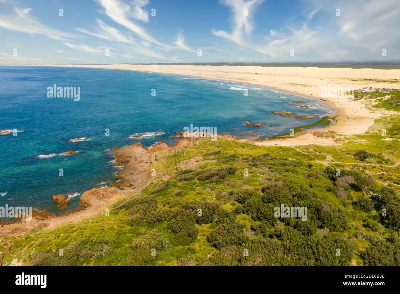 Aerial view of the Stockton Sand Dunes and blue water of the Tasman Sea ...