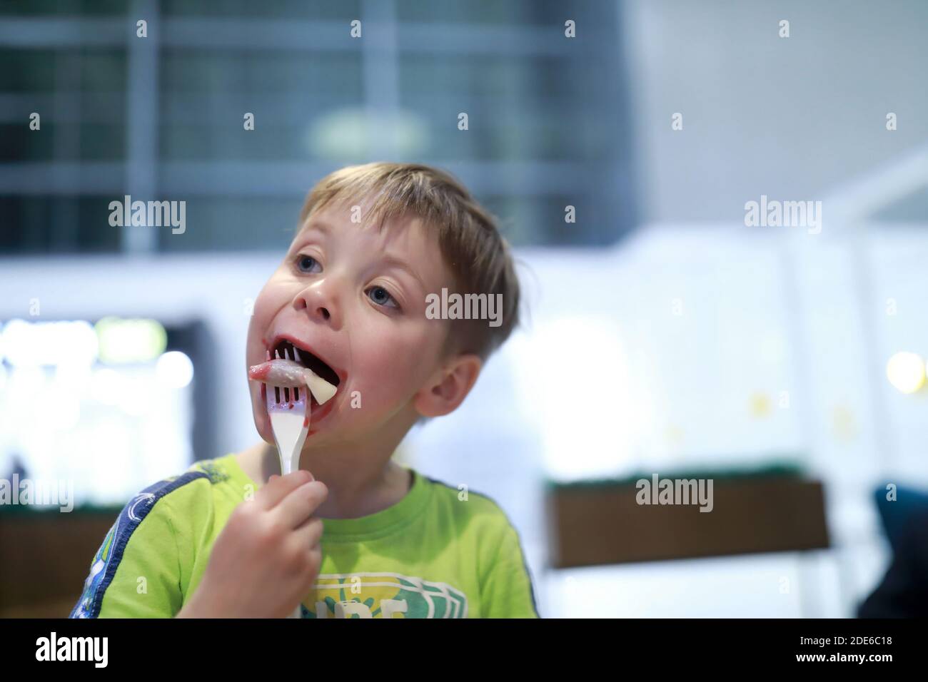 Boy eating cherry dumplings in a cafe Stock Photo - Alamy