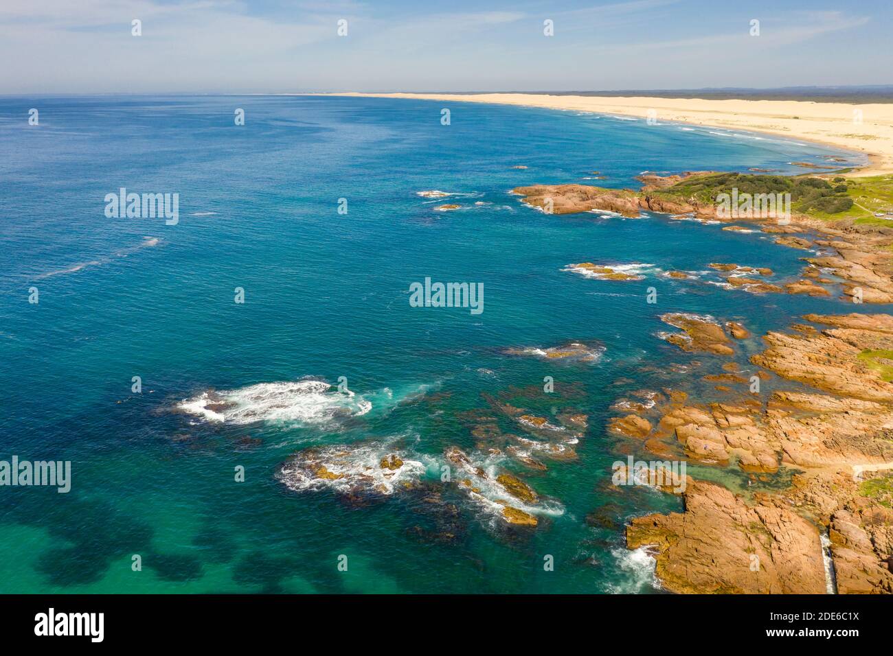 Aerial view of the Stockton Sand Dunes and blue water of the Tasman Sea ...
