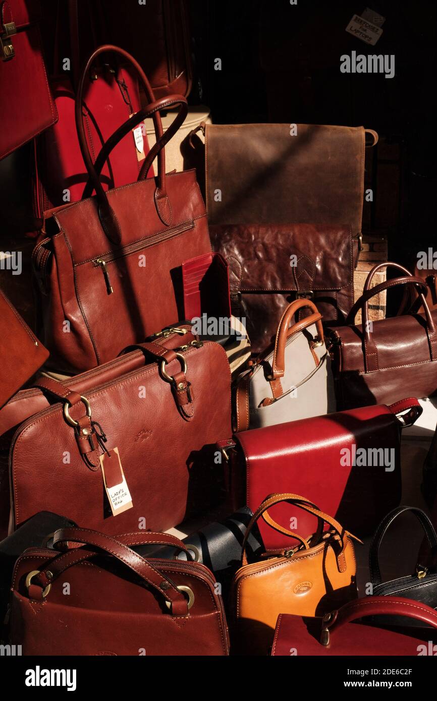 Shop window display of similar coloured leather bags Stock Photo - Alamy