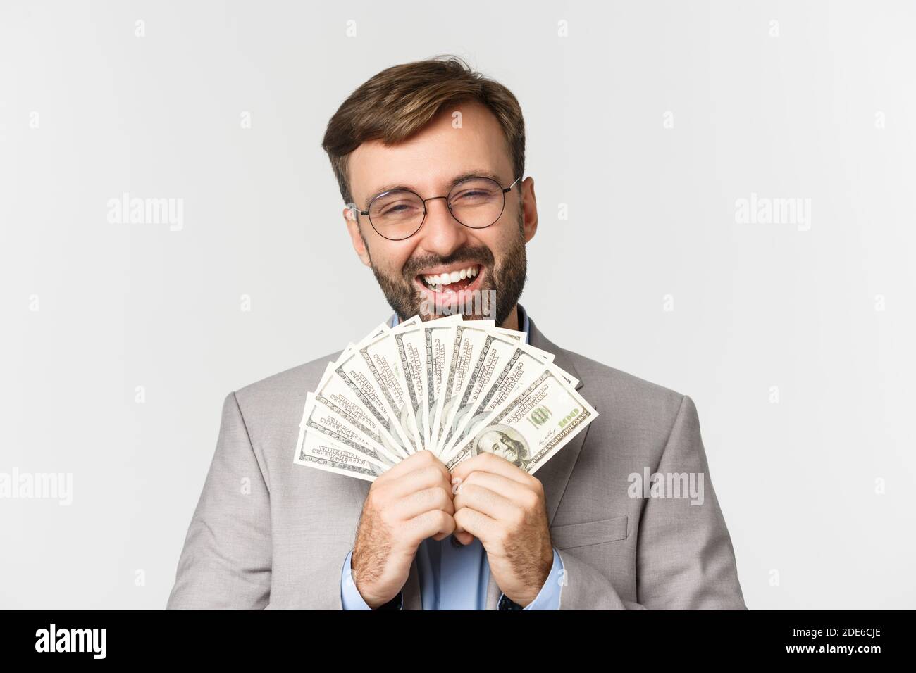 Close-up of rich and successful businessman, wearing gray suit and ...