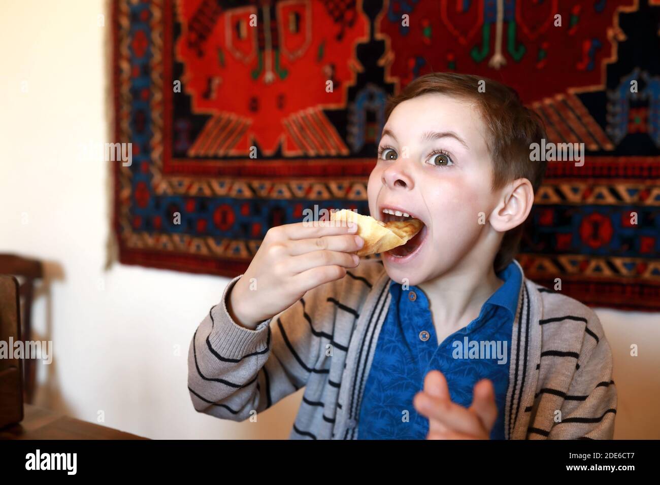 Child eating khachapuri in a georgian restaurant Stock Photo - Alamy