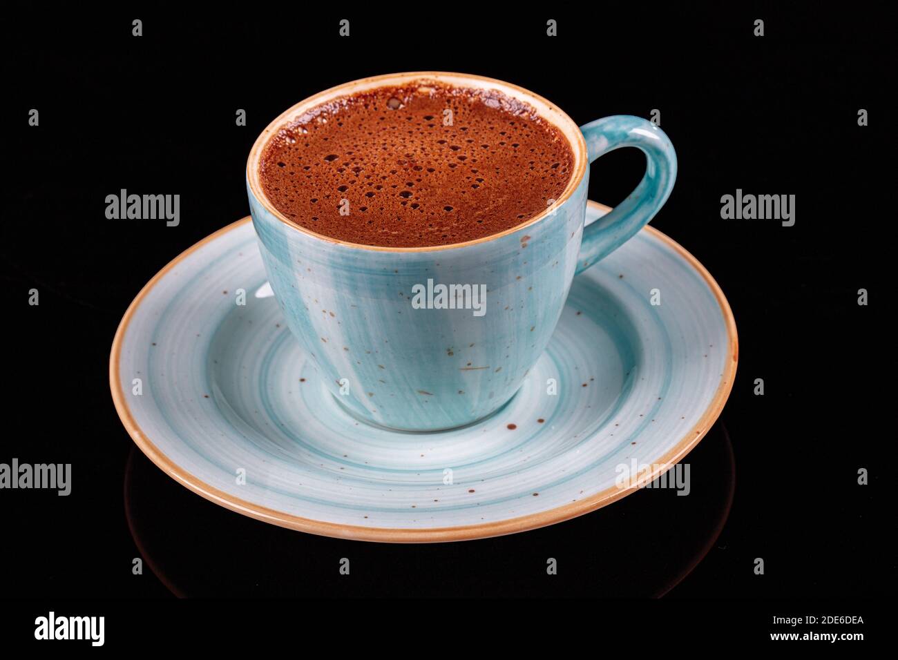 Turkish coffee in blue porcelain cup isolated on black background Stock ...