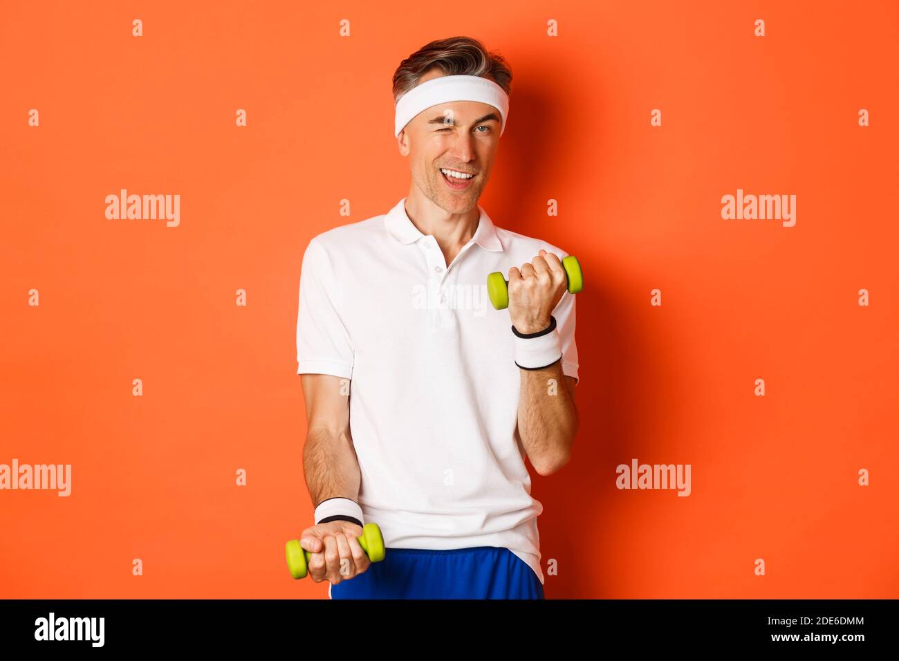 Portrait of handsome cheeky, middle-aged male athlete doing sports ...