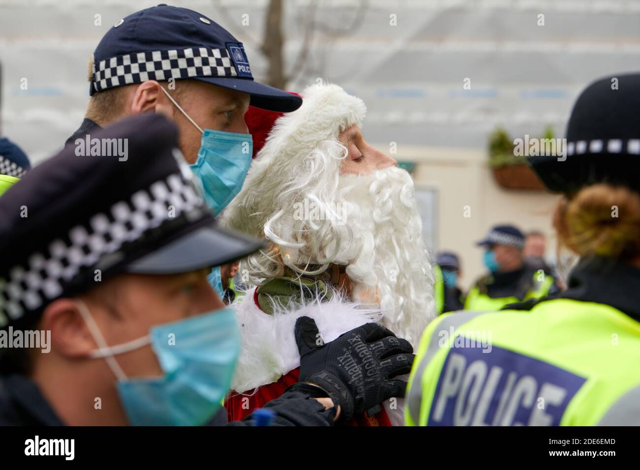 London, UK. - 28 Nov 2020: A man dressed as Santa Claus is led away ...