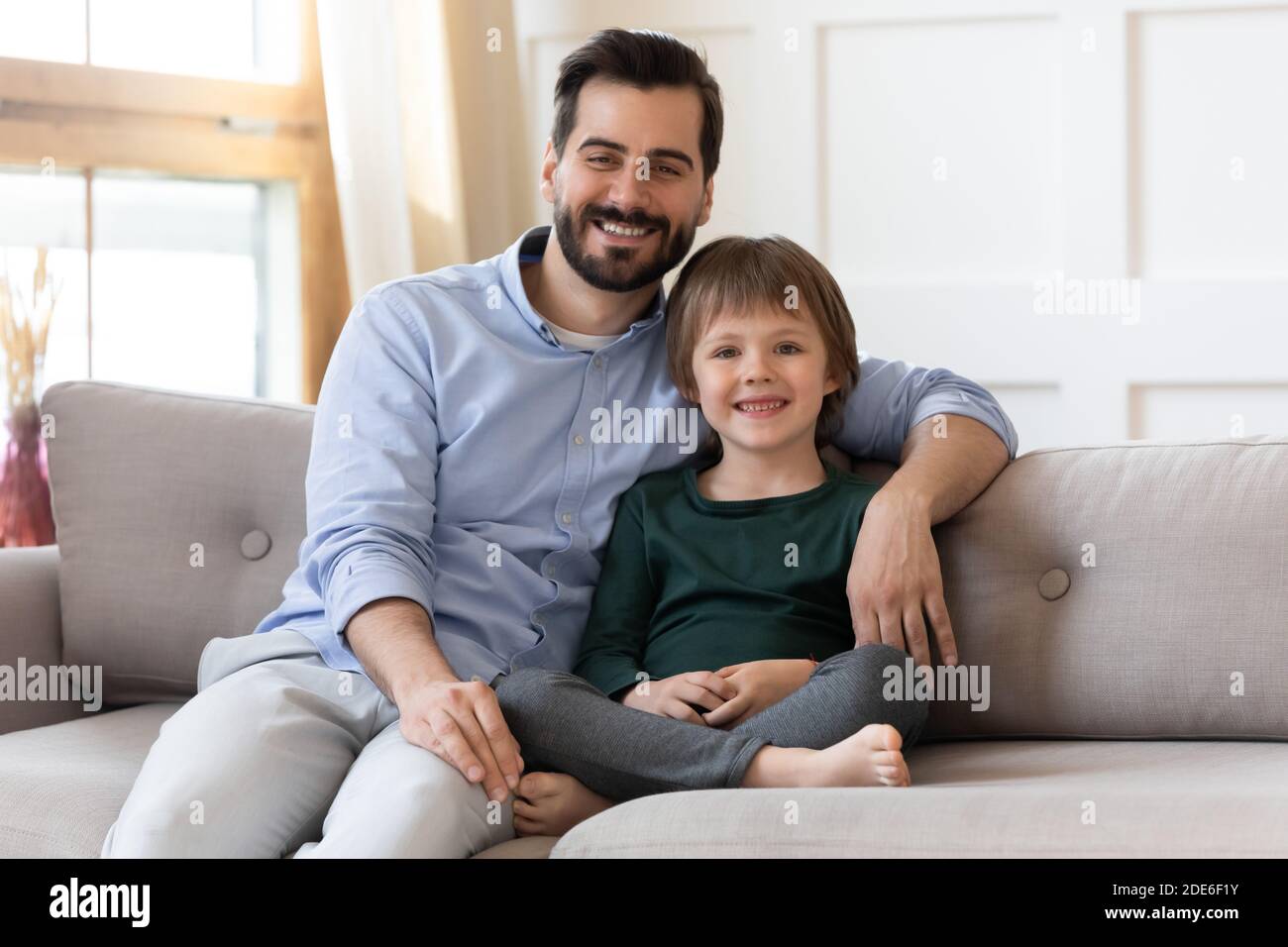 Portrait of happy dad and son relax on couch Stock Photo - Alamy