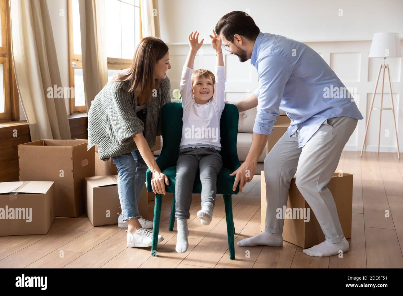 Happy parents settle in new house with little son Stock Photo - Alamy