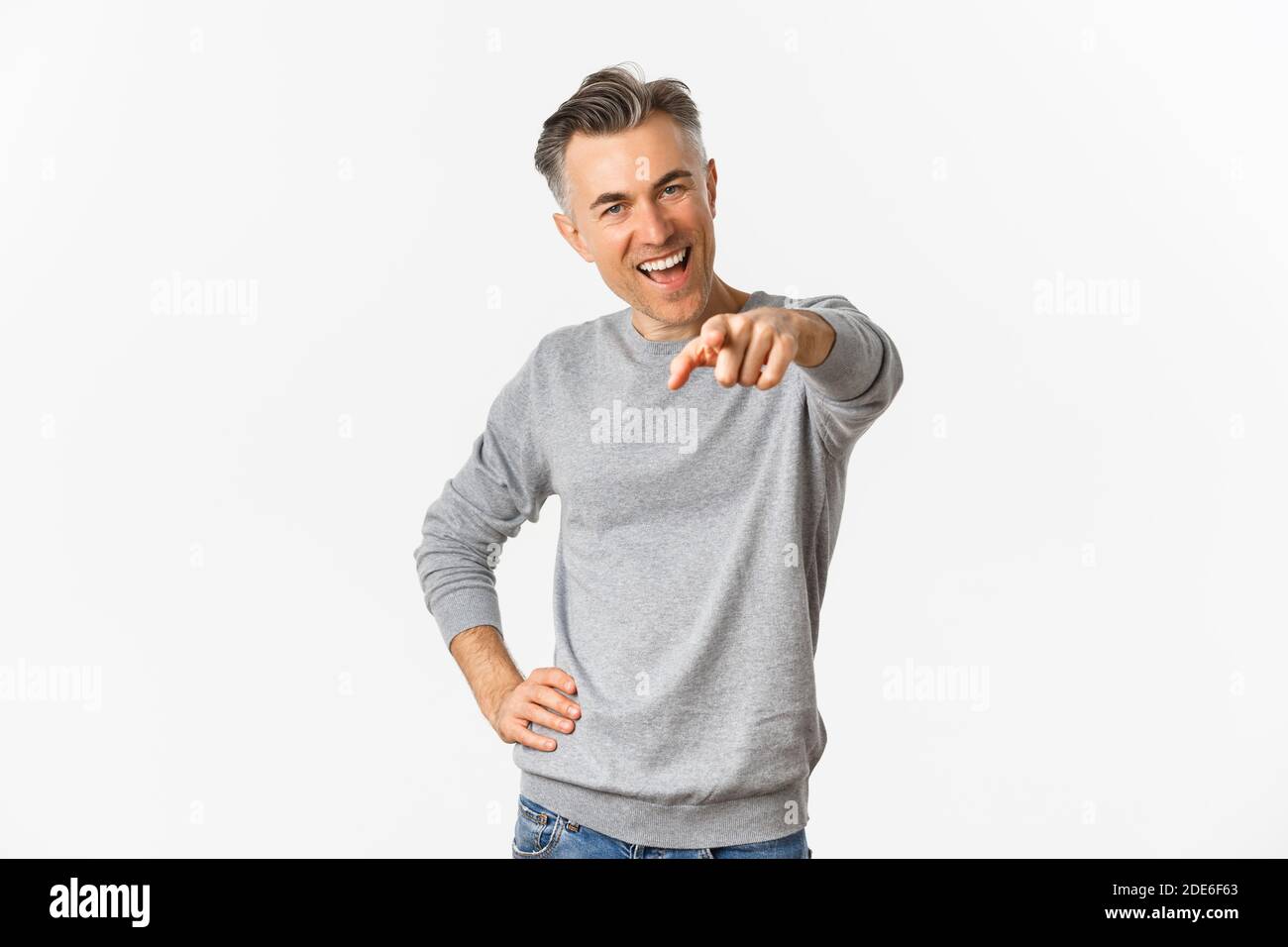 Image of handsome middle-aged man smiling and pointing finger at camera ...