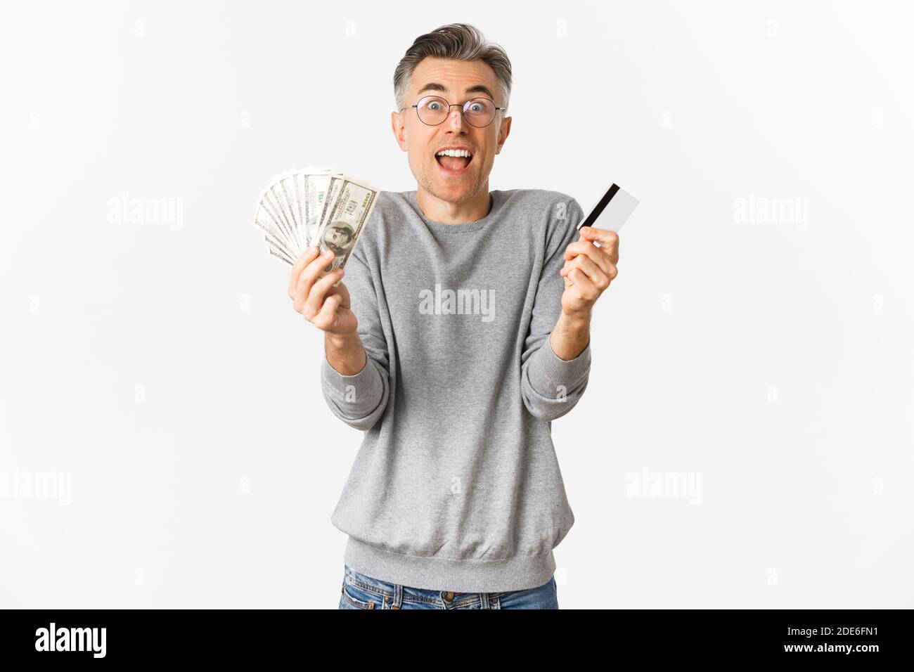 Portrait of happy and excited middle-aged man, showing credit card and ...